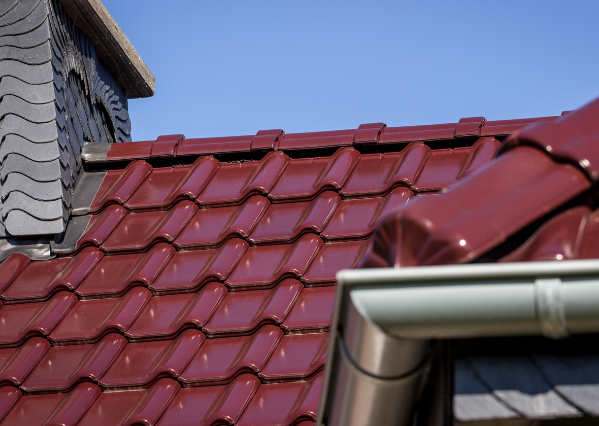 Fine wine red flat roof tile J11v on a beautiful country house